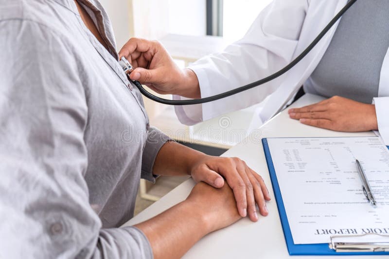 Doctor Using a Stethoscope Checking Patient about the Problem of ...