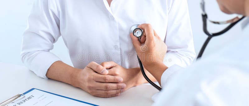 Doctor Using a Stethoscope Checking Patient about the Problem of ...