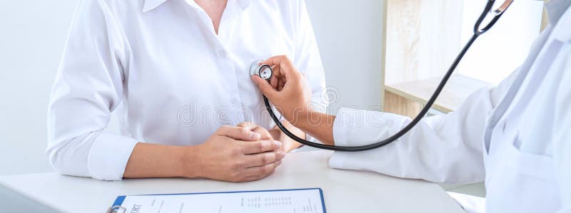 Doctor Using a Stethoscope Checking Patient about the Problem of ...