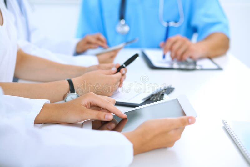 Doctor Using Tablet Computer at Medical Meeting, Closeup. Group of ...