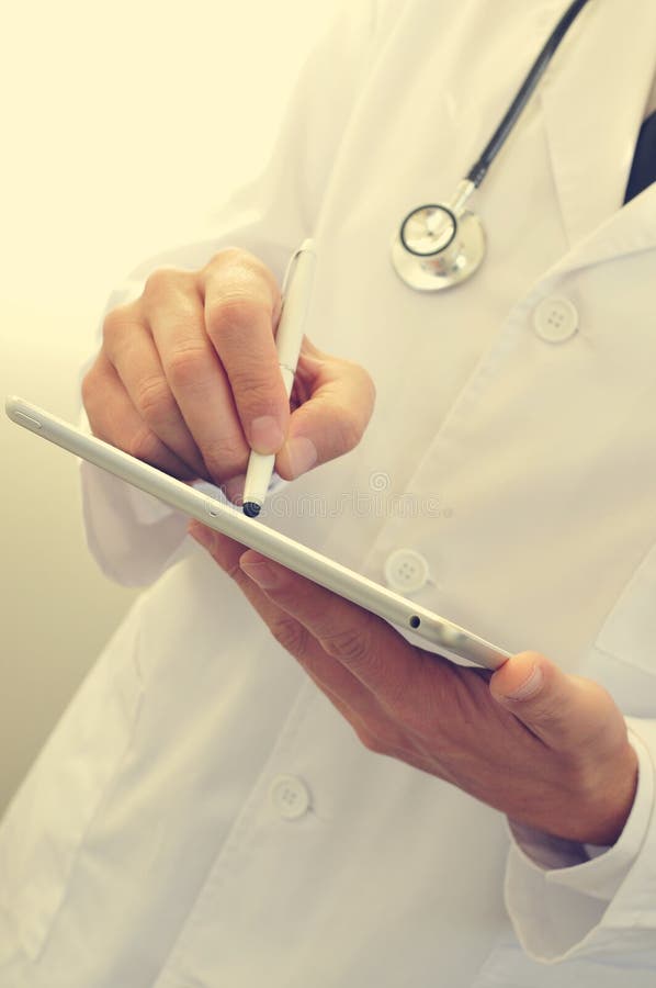 Doctor using a tablet stock image. Image of practitioner - 49890101