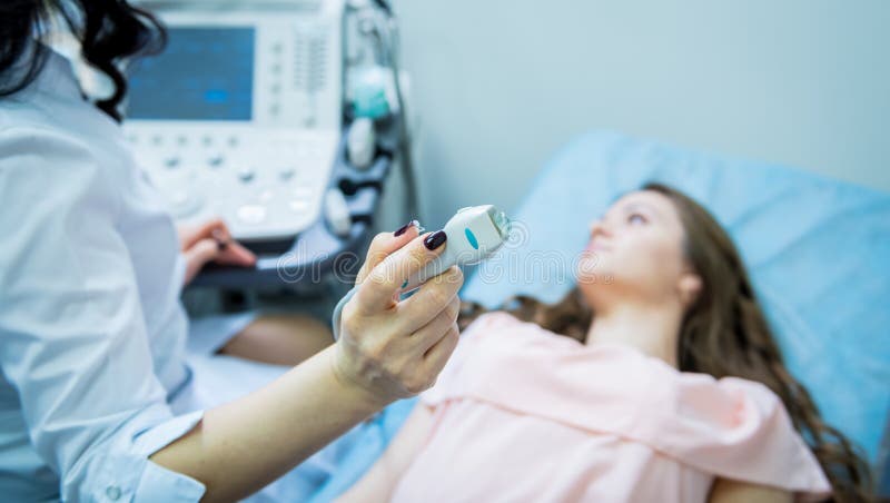 Doctor Using Ultrasound Scanning Machine for Examining a Thyroid of ...
