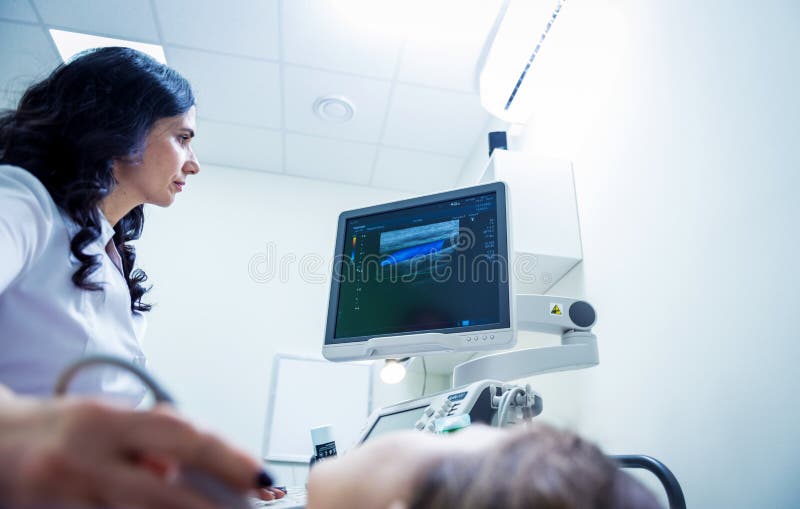 Doctor Using Ultrasound Scanning Machine for Examining a Thyroid of ...