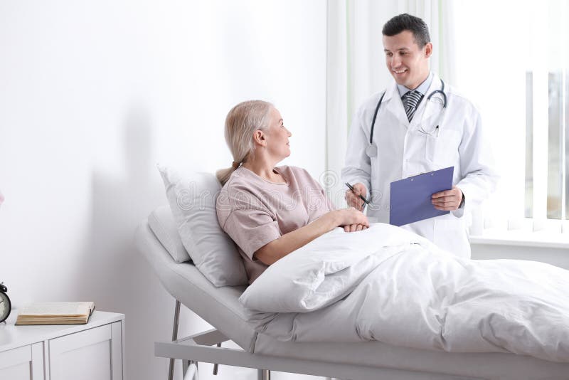 Doctor Visiting His Patient in Hospital Stock Image - Image of mature ...