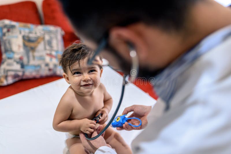 Doctor watching a baby stock photo. Image of pediatric - 159942892