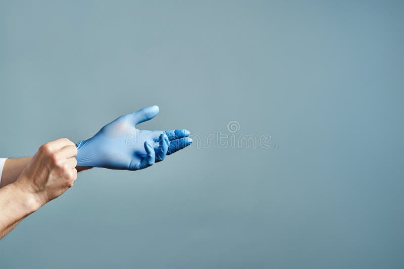 Doctor Wearing a Blue Glove in the Operating Room. Light Blue Blurred ...