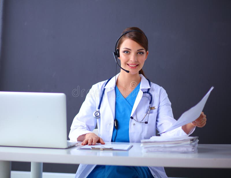 Doctor Wearing Headset Sitting Behind a Desk with Laptop Stock Image ...