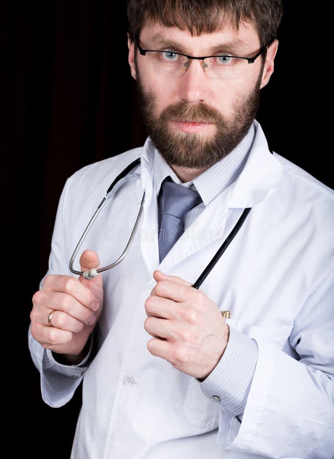 Doctor in a White Medical Robe, Standing and Holding a Stethoscope ...