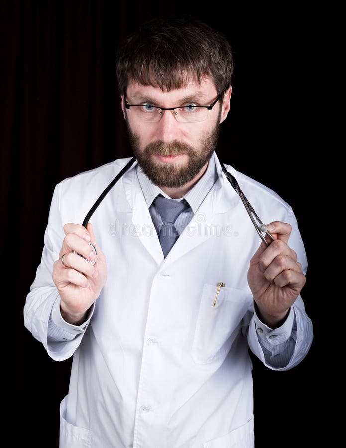 Doctor in a White Medical Robe, Standing and Holding a Stethoscope ...