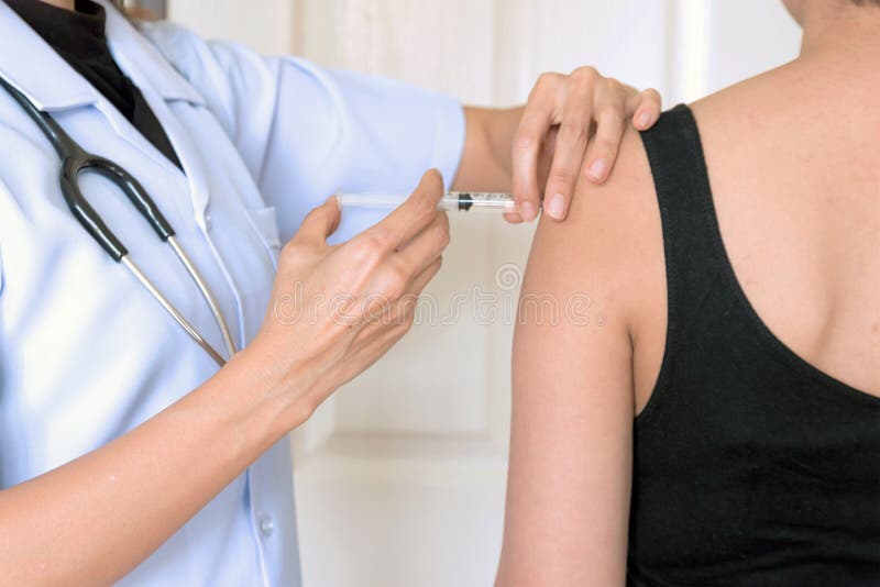 Doctor Woman Giving a Woman Injection in Arm Stock Photo - Image of ...