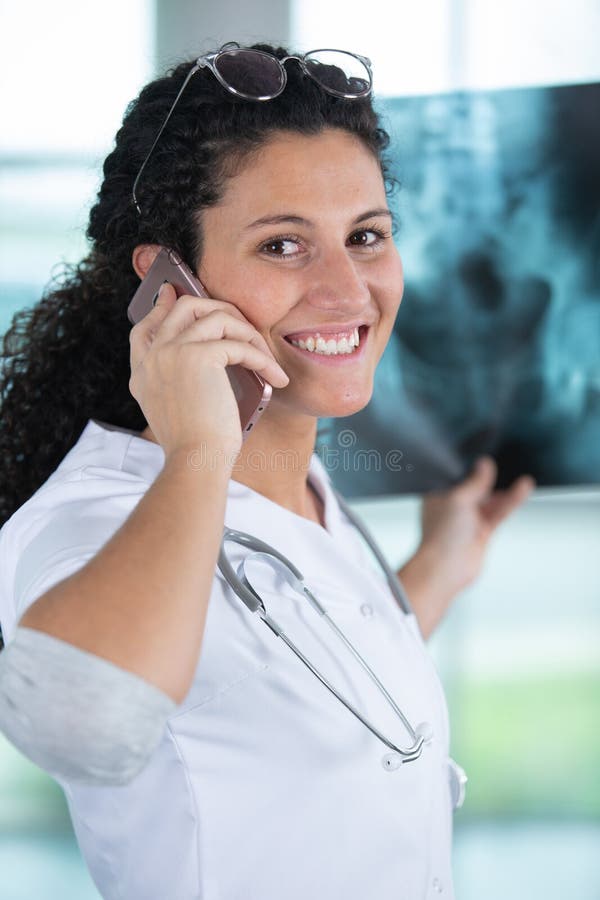 Doctor Woman Hold X Ray Scan while Talking on Phone Stock Image - Image ...