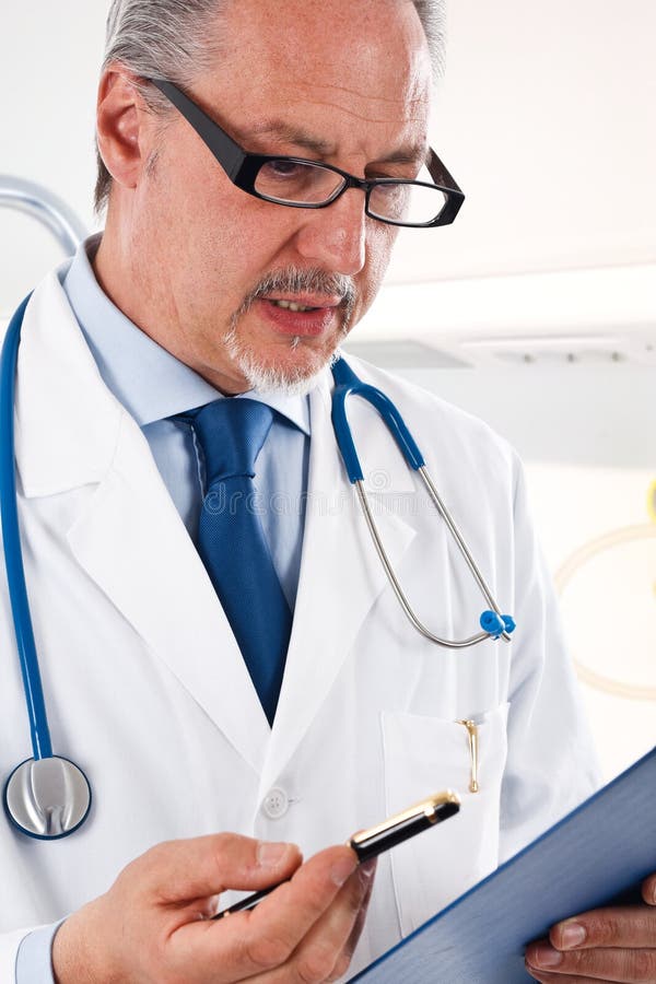 Doctor at Work Reading a Clipboard Stock Photo - Image of case, health ...