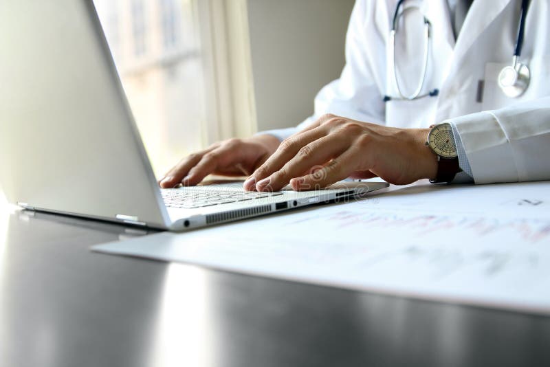 Doctor Working on a Computer at His Cabinet Stock Photo - Image of ...