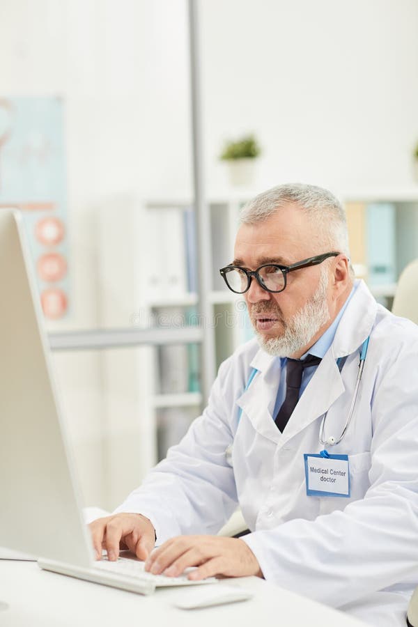 Doctor working on computer stock image. Image of cheerful - 166198513