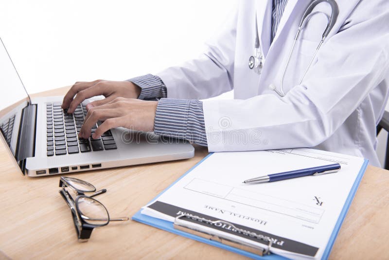 Doctor Working on Desktop Computer and Prescription Paper Stock Photo ...