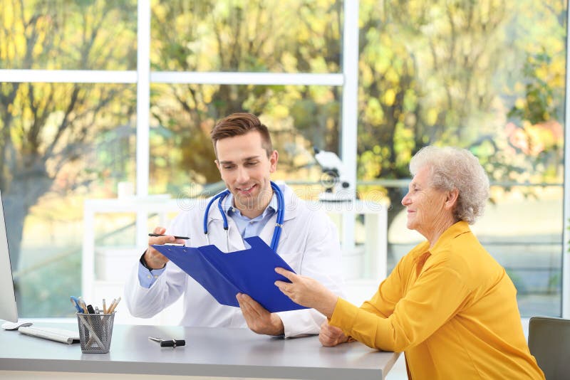 Doctor Working with Elderly Patient Stock Photo - Image of people ...