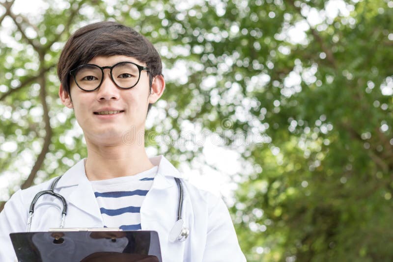 Doctor working in garden stock image. Image of asian - 95702355