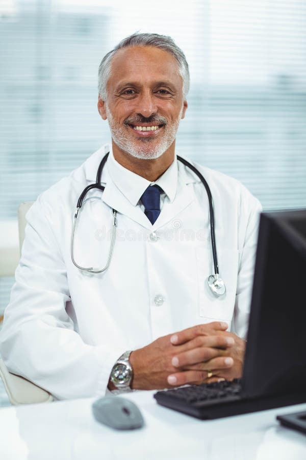 Doctor Working on His Computer Stock Image - Image of caucasian, coat ...