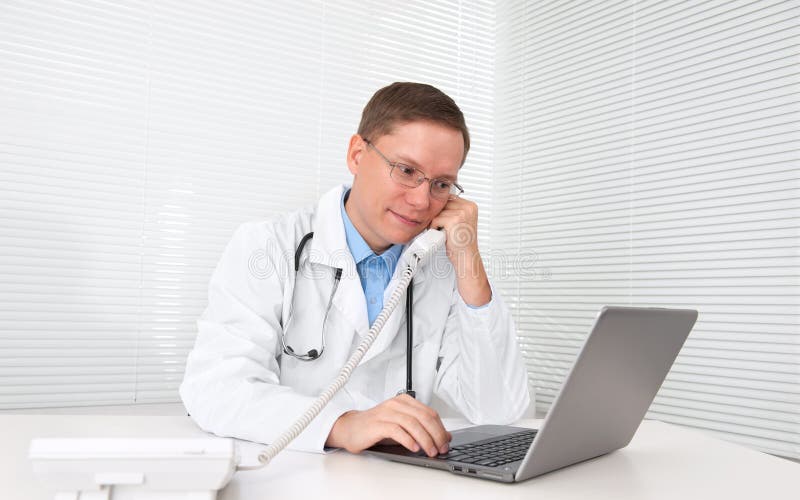 Doctor working on a laptop stock image. Image of office - 27247545