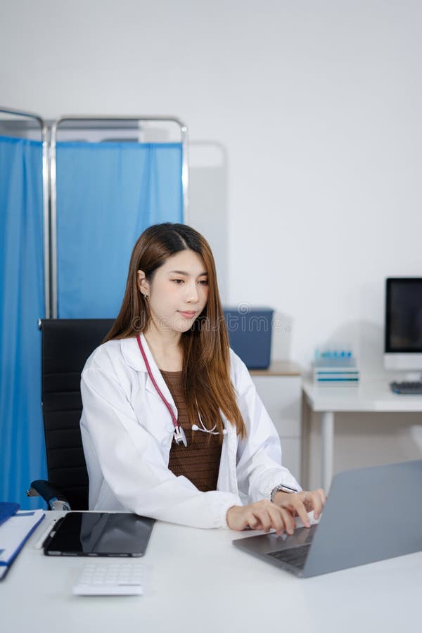 Doctor Working on Laptop Computer and Tablet and Medical Stethoscope on ...