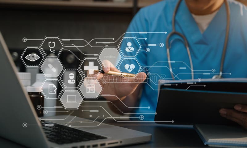 Doctor Working with Laptop Computer and Writing on Paperwork Stock ...