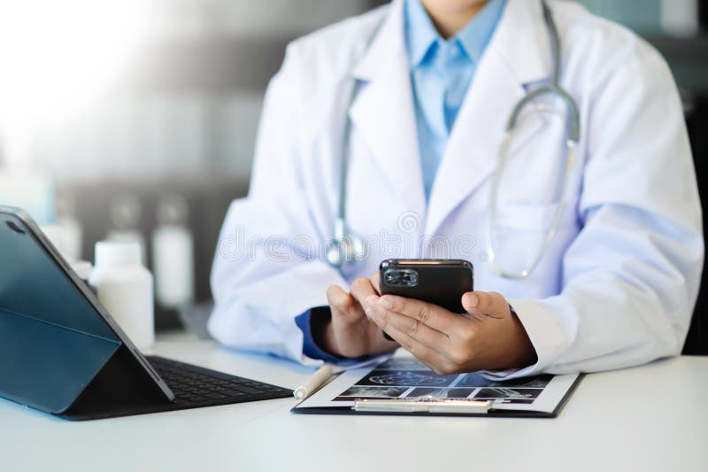 Doctor Working with Mobile Phone and Stethoscope in Office. Medical ...