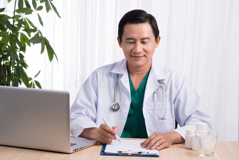 Doctor Working at Table in Office Stock Image - Image of indoors ...