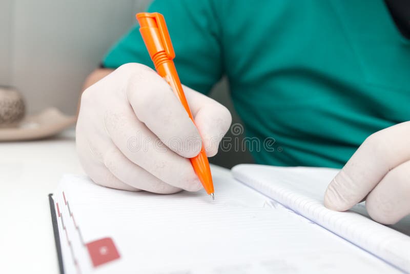 The Doctor Writes in a Notebook at the Clinic Stock Photo - Image of ...