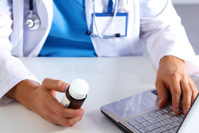 The Doctor Writes a Prescription Pill on the Computer Stock Photo ...