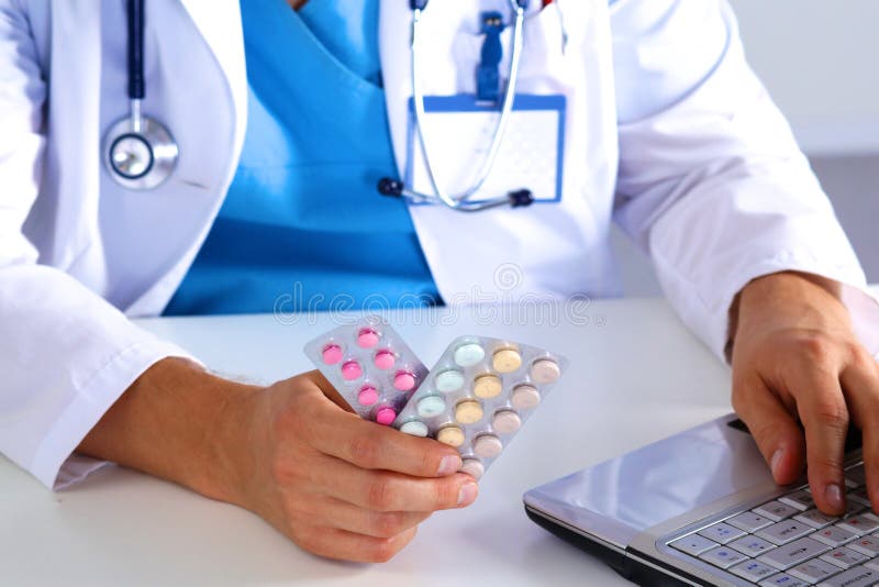 The Doctor Writes a Prescription Pill on the Computer Stock Photo ...