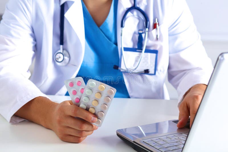 The Doctor Writes a Prescription Pill on the Computer Stock Photo ...