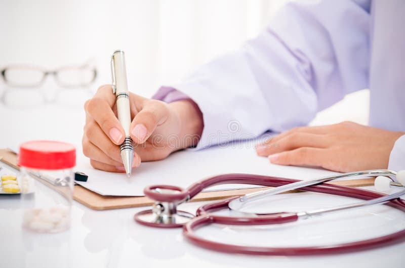 Doctor Writing Medical Record Stock Photo - Image of business, glasses ...
