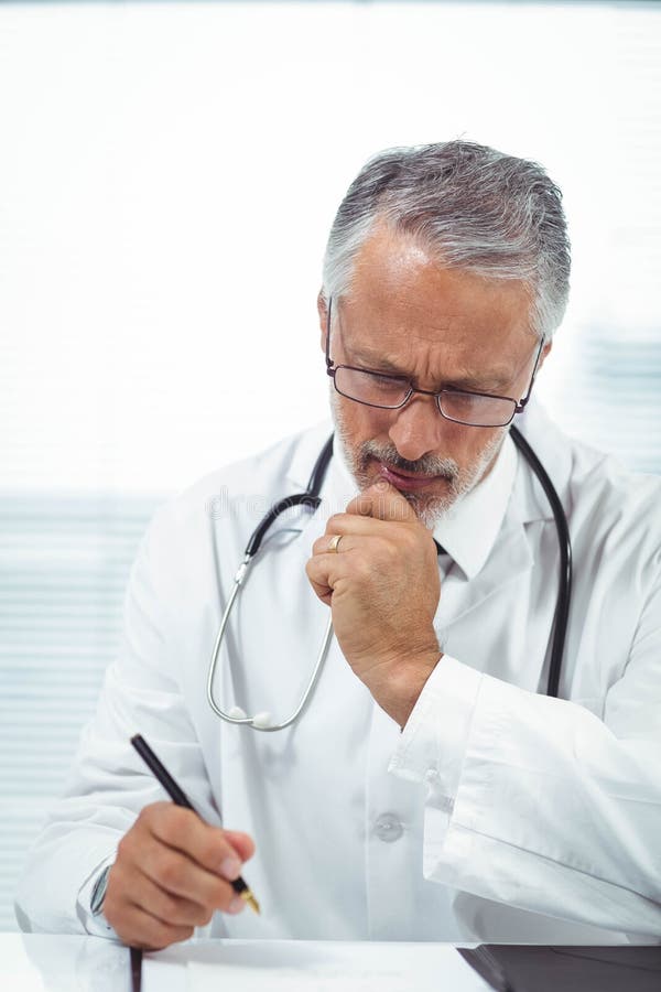 Doctor writing on notepad stock photo. Image of confidence - 67533392