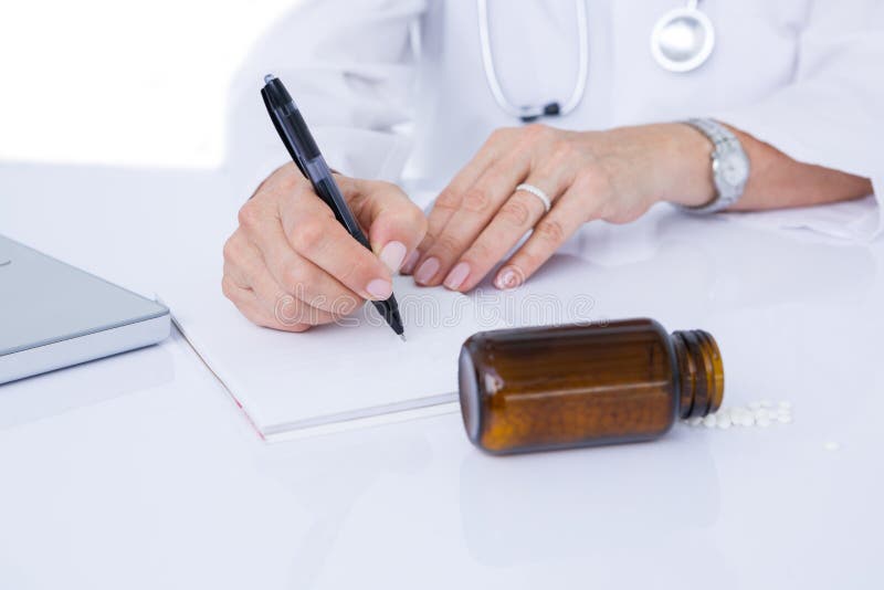 Doctor Writing on a Notepad Stock Photo - Image of shot, technology ...