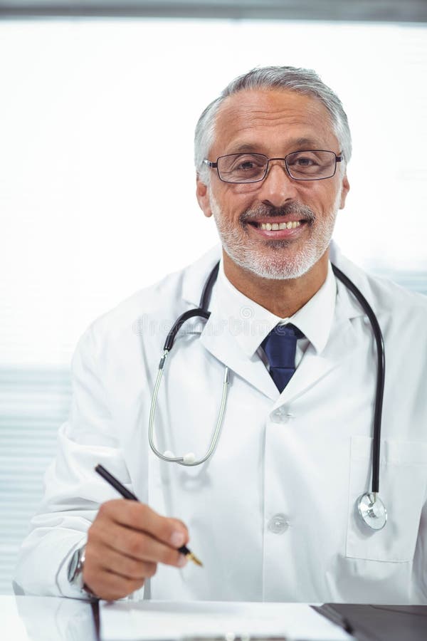 Doctor writing on notepad stock image. Image of male - 67533259