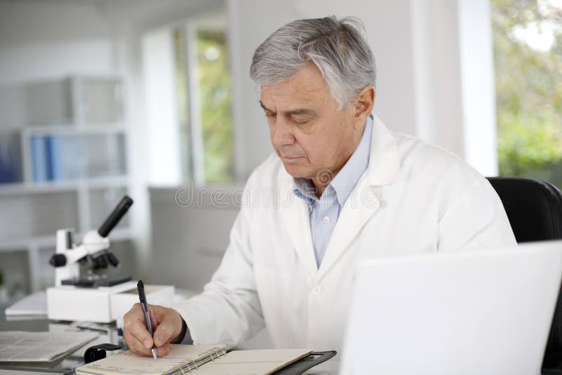 Doctor Writing Notes in Laboratory Stock Image - Image of agenda ...