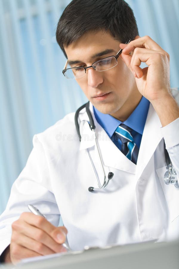 Doctor writing at office stock image. Image of medicaid - 6894849