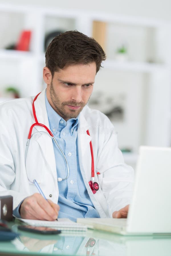 Doctor writing in office stock photo. Image of caucasian - 82890302