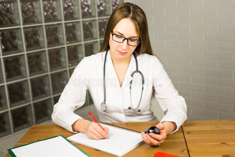 Doctor Writing on Paper at Clinic Stock Photo - Image of expertise ...