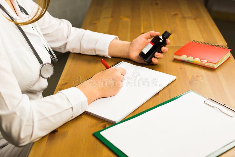 Doctor Writing on Paper at Clinic Stock Image - Image of male, hospital ...