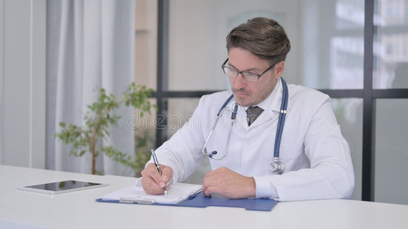 Doctor Writing on Paper in Clinic Stock Image - Image of illness ...