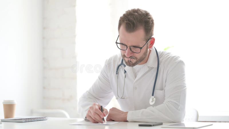 Doctor Writing on Paper in Clinic Stock Image - Image of contemplation ...