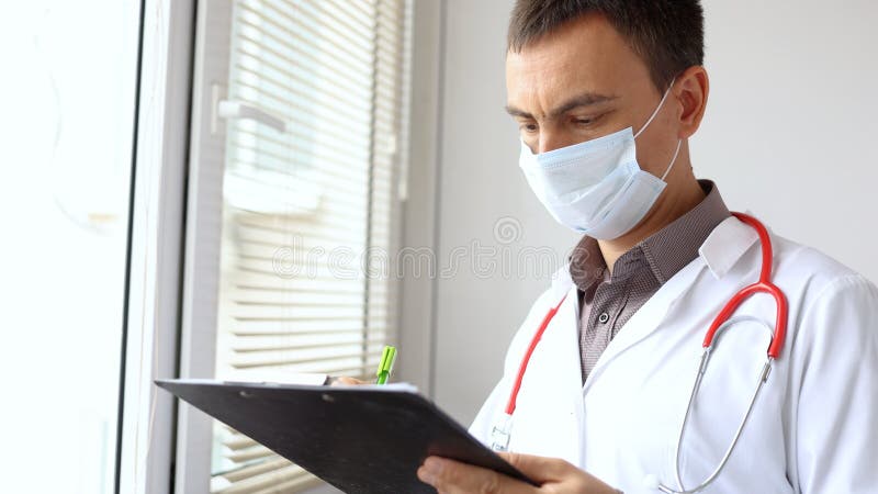 Doctor Writing Patient Notes on a Medical Examination or Prescription ...