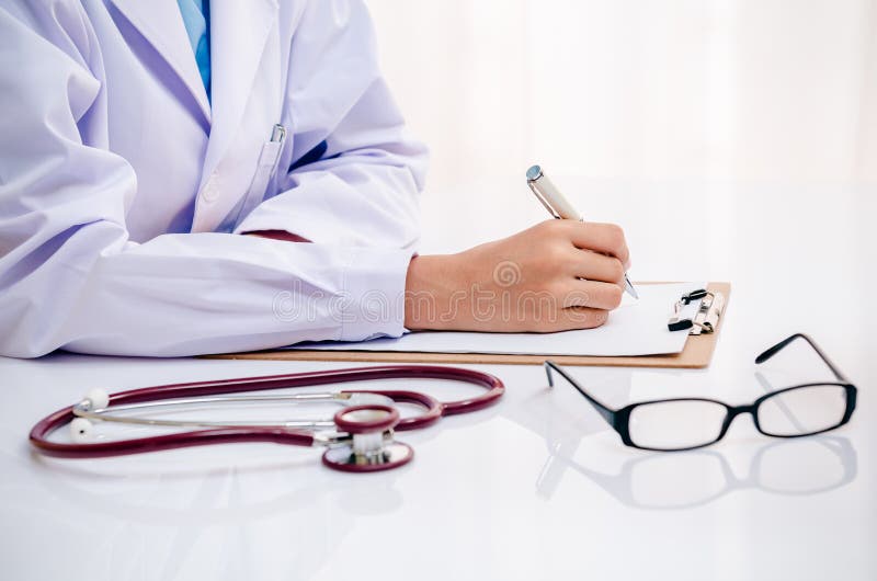 Doctor writing on table stock image. Image of healthcare - 55462337