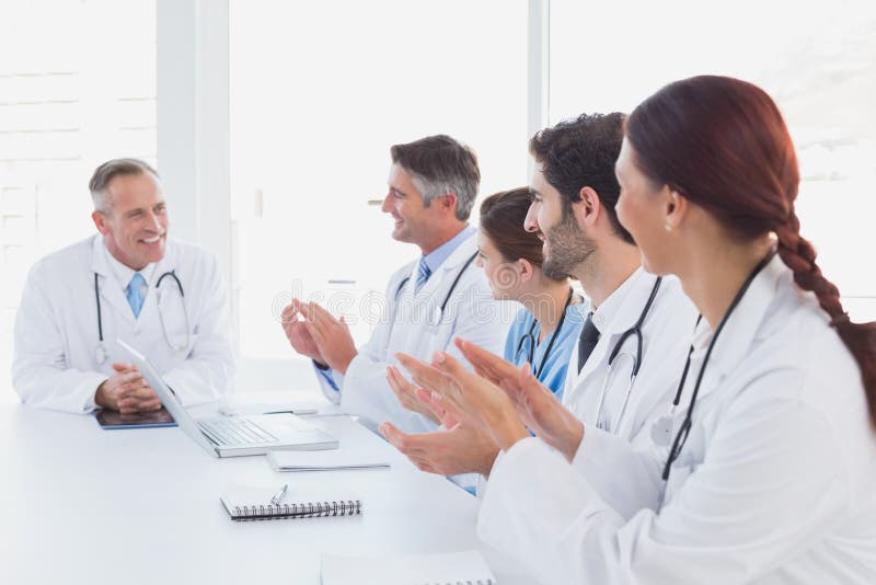 Doctors Applauding a Fellow Doctor Stock Image - Image of mature ...