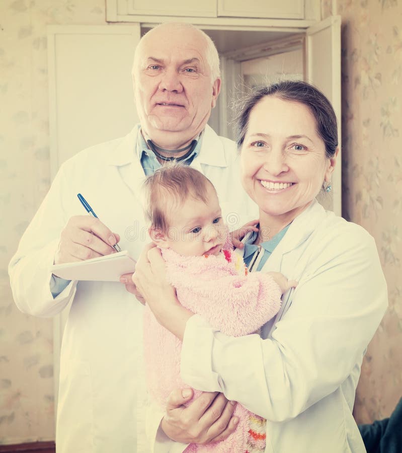 Doctors With Baby In Interior Stock Image - Image of family, happy ...