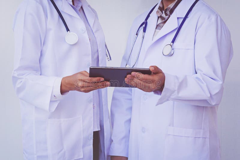 Doctors Checking Patient Information on a Tablet Device Stock Image ...