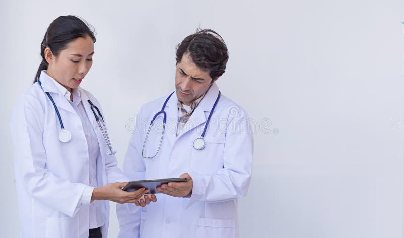 Doctors Checking Patient Information on a Tablet Device Stock Photo ...