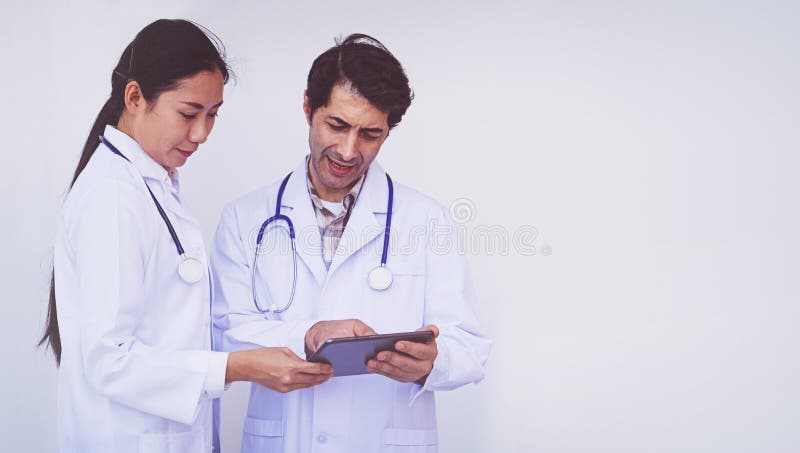 Doctors Checking Patient Information on a Tablet Device Stock Photo ...