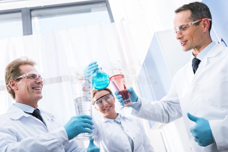 Doctors Clinking Test Tubes Stock Photo - Image of smile, attractive ...